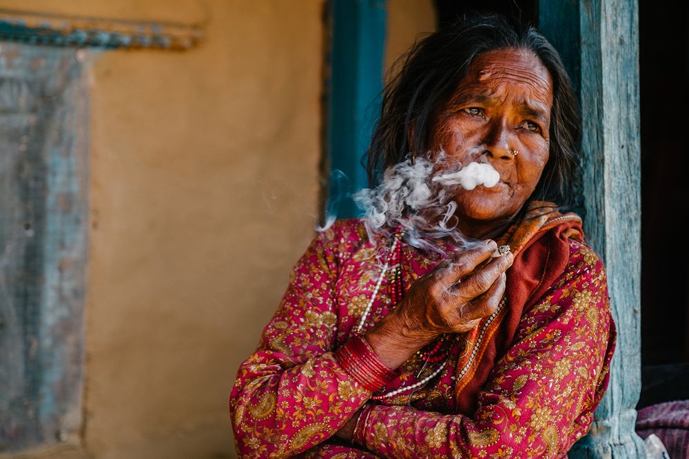 Adrian Popan - Portrait of a Nepali woman smoking a cigarette | LensCulture